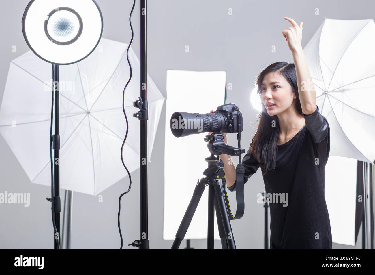 Photographer taking picture in studio Stock Photo - Alamy