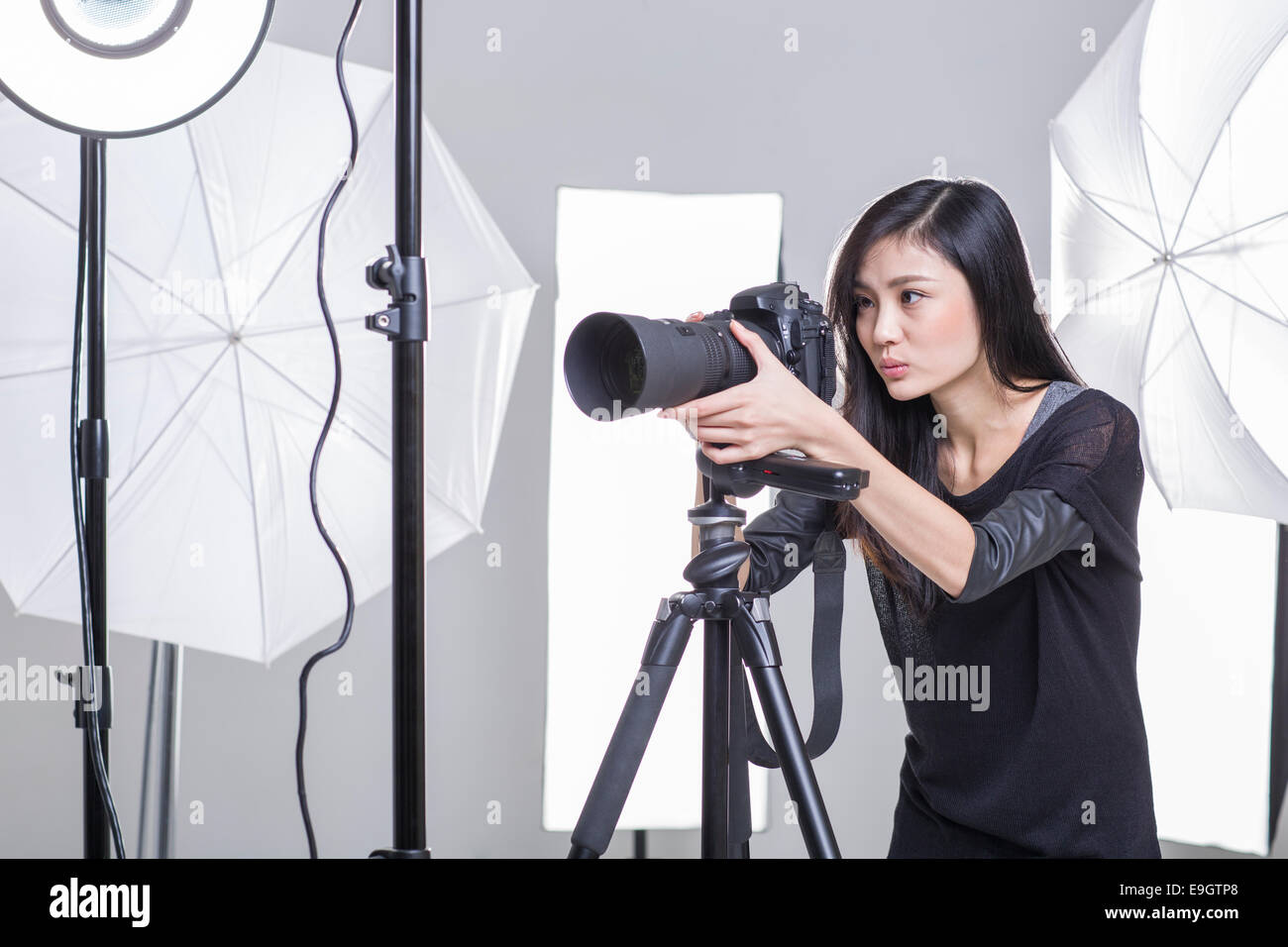 Photographer taking picture in studio Stock Photo - Alamy