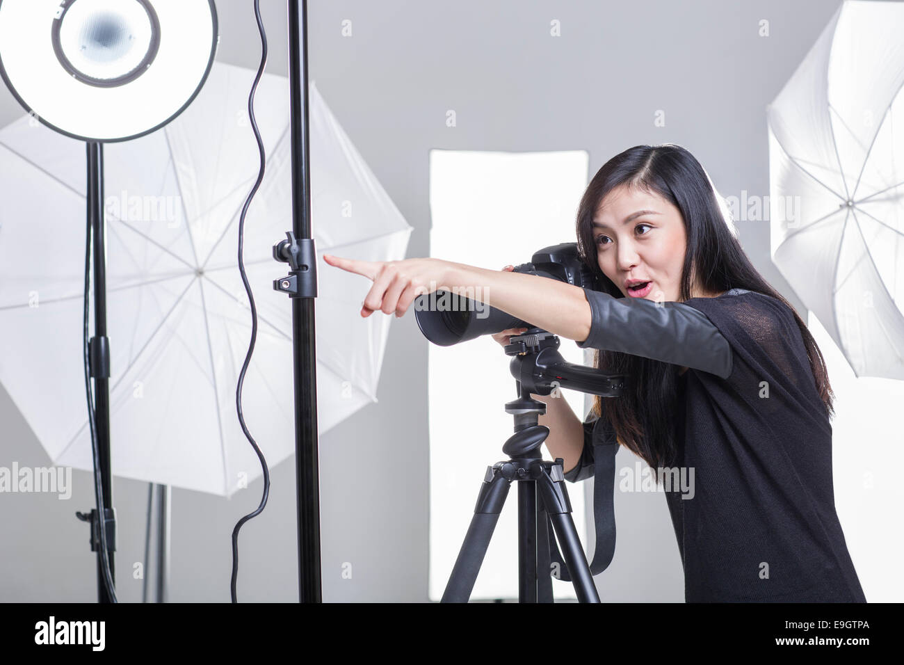 Photographer taking picture in studio Stock Photo - Alamy