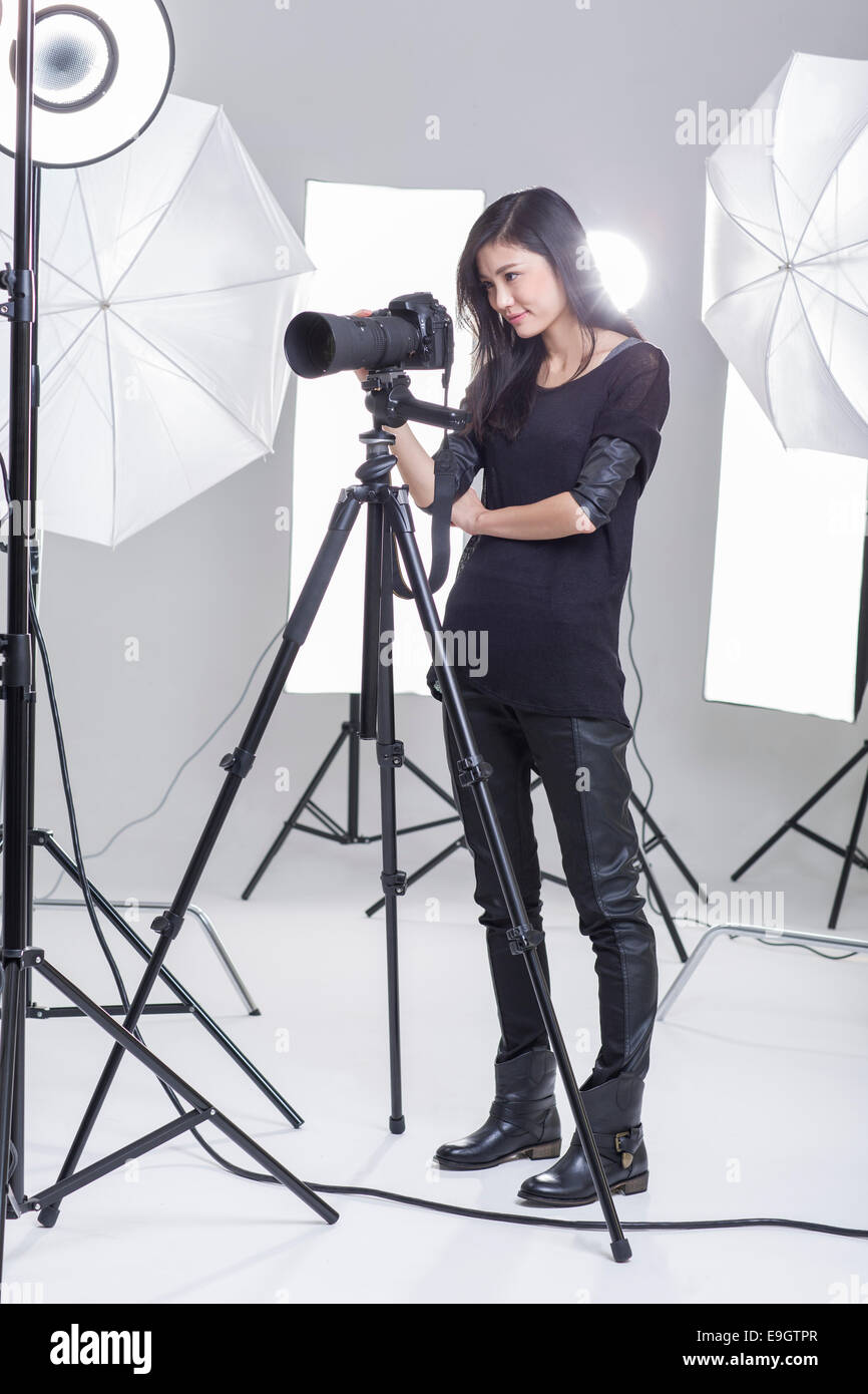 Photographer taking picture in studio Stock Photo - Alamy
