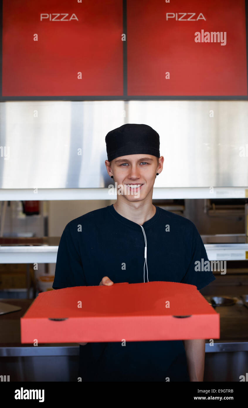 Boy delivering pizza at fast food restaurant Stock Photo - Alamy