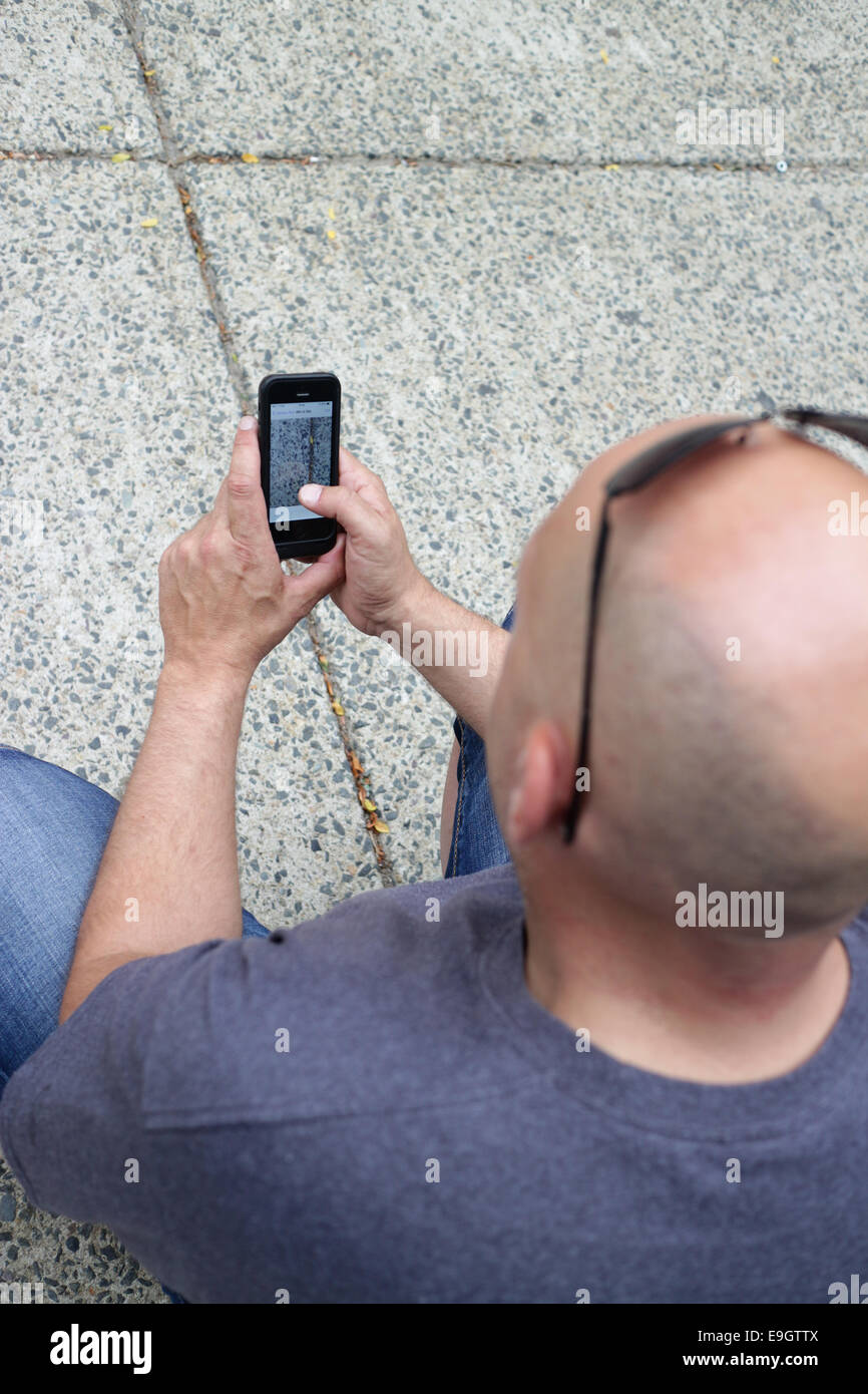 Man holding a smartphone, shot from above Stock Photo - Alamy