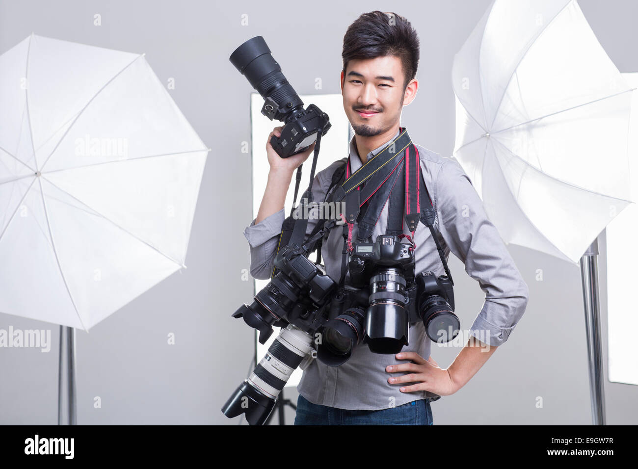 Portrait of photographer with many cameras hanging on his neck Stock ...