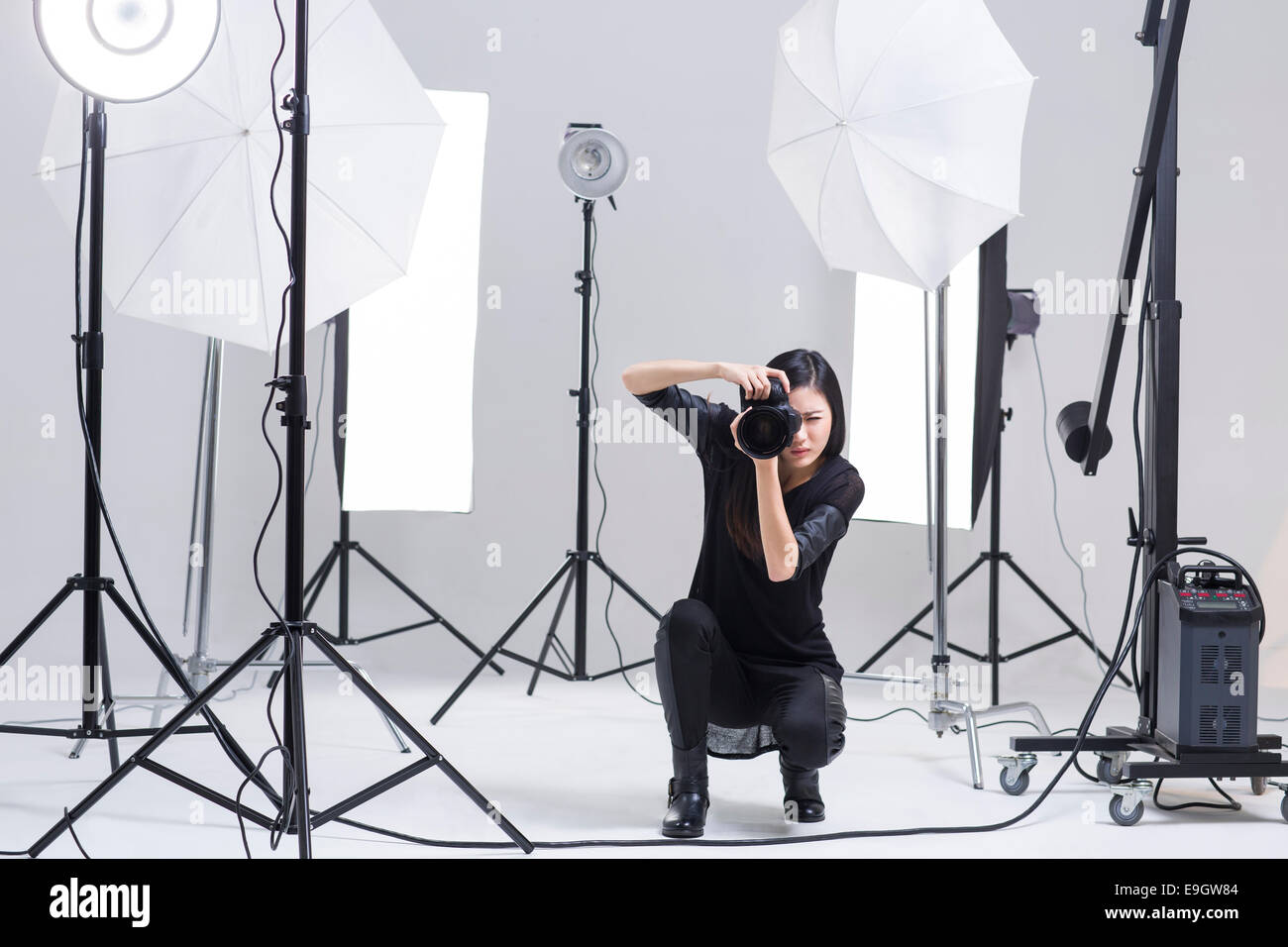 Photographer taking picture in studio Stock Photo - Alamy