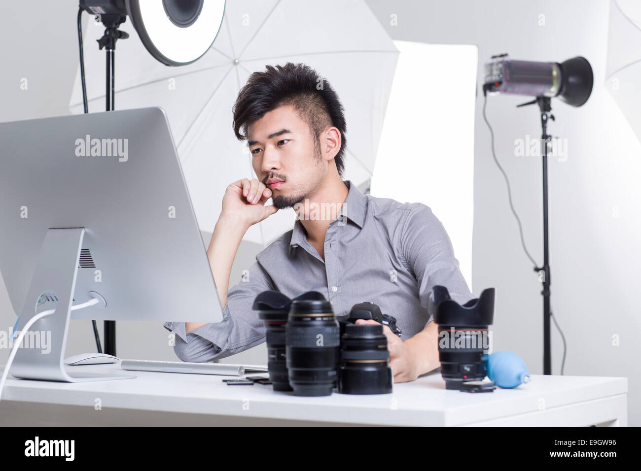 Photographer working in studio with computer Stock Photo - Alamy