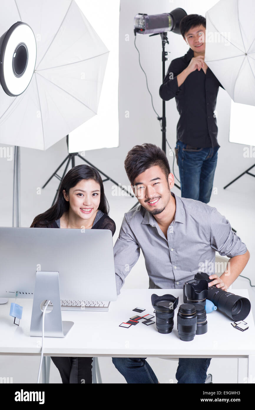 Two photographers working in studio with computer Stock Photo - Alamy