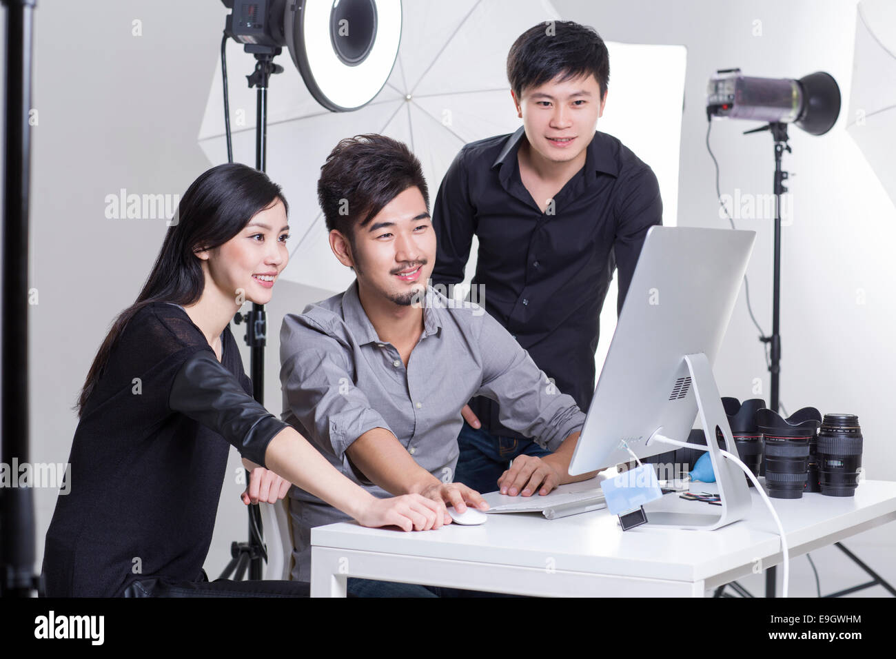 Photographers working in studio with computer Stock Photo - Alamy