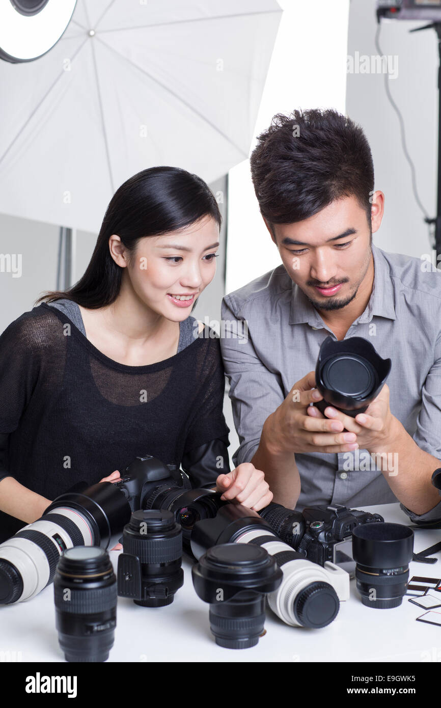 Two photographers working in studio Stock Photo - Alamy