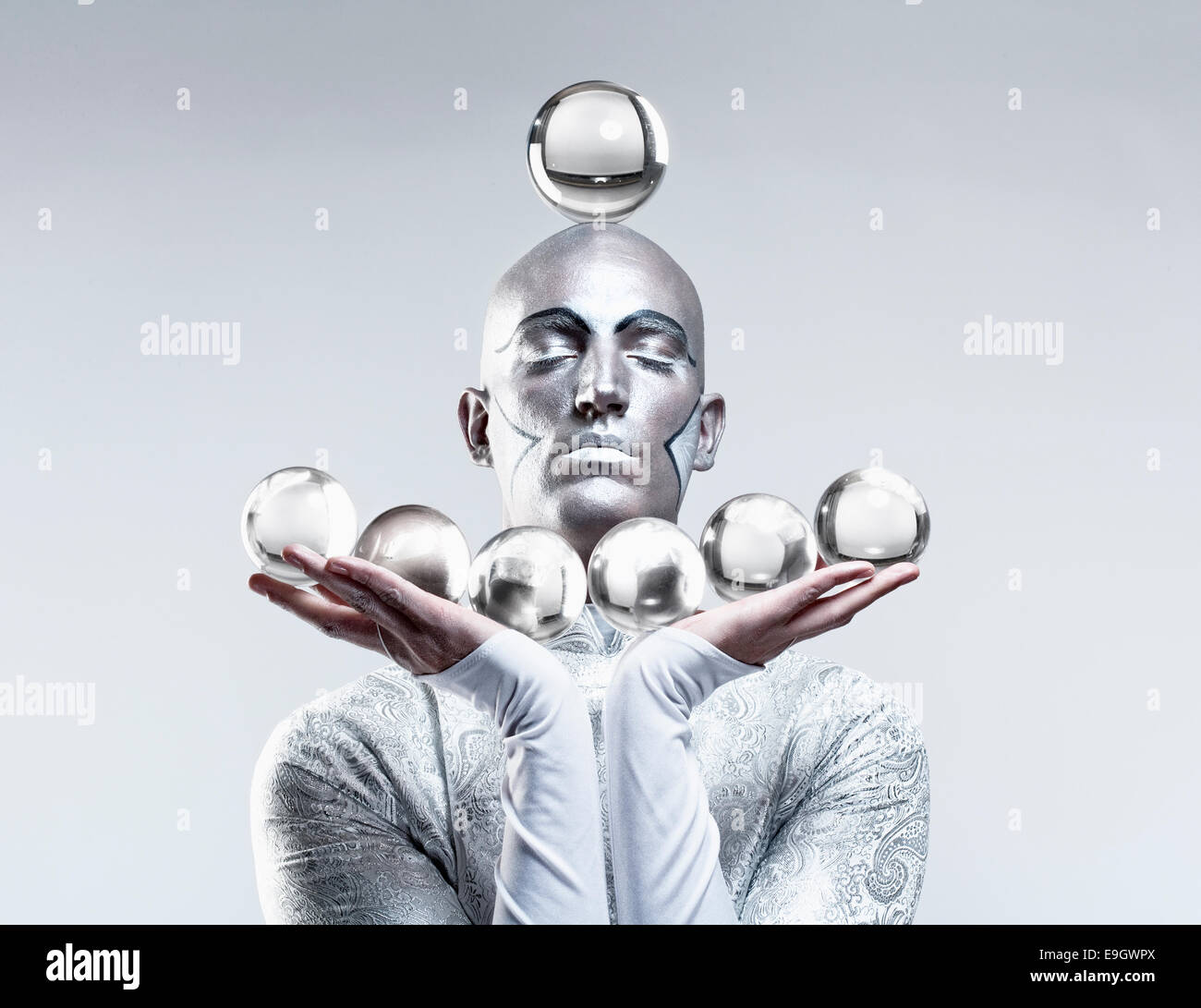 Magician with Glass Balls in Stage Makeup and Costume Stock Photo - Alamy