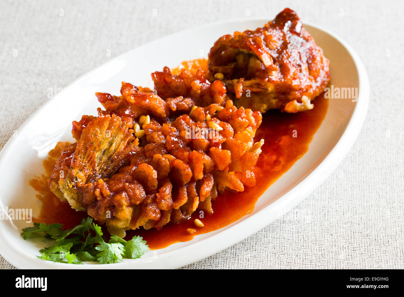 Chinese cuisine fish with pine nuts Stock Photo - Alamy