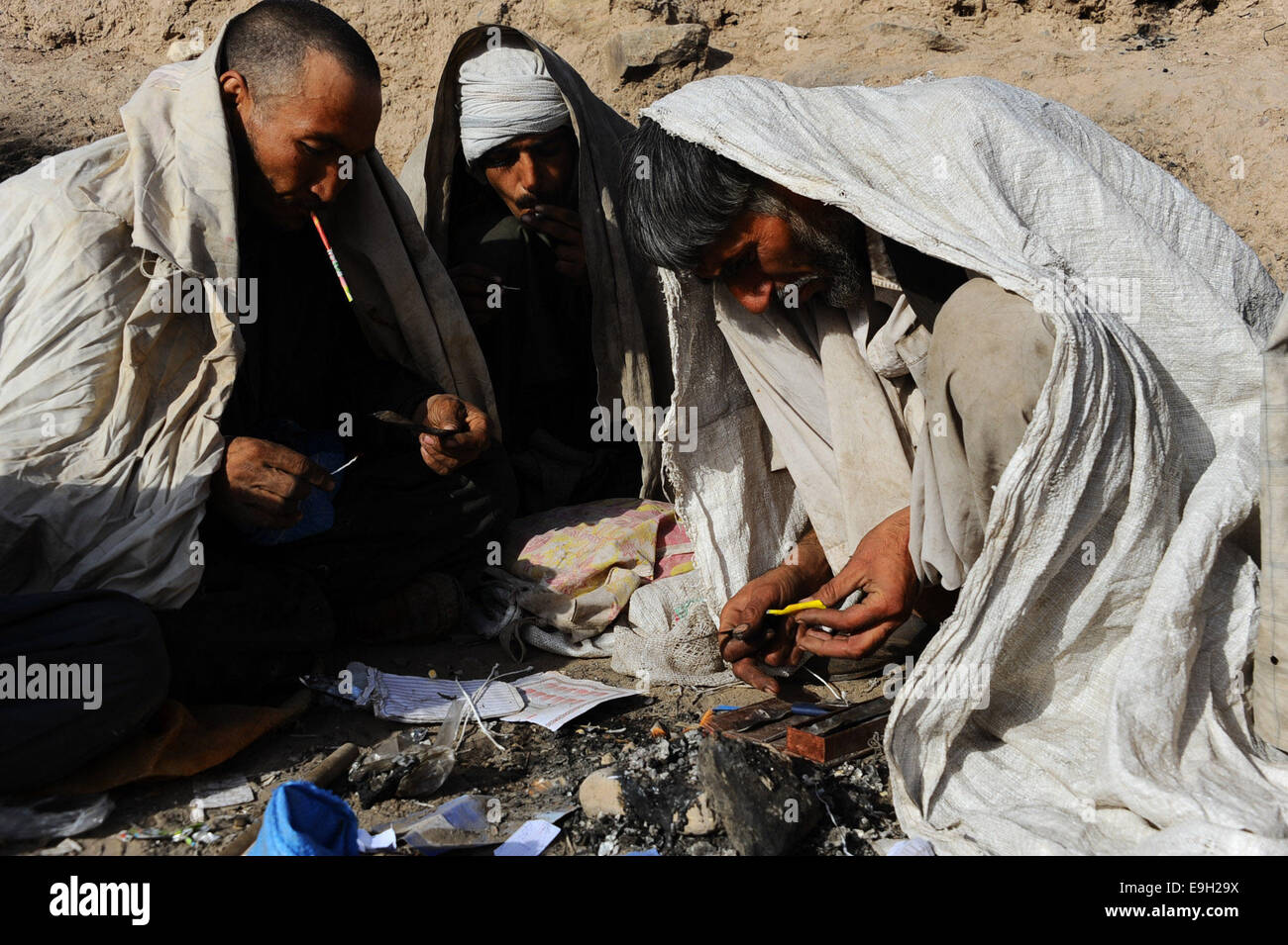 Herat, Afghanistan. 28th Oct, 2014. Afghan drug addicts smoke heroin at ...