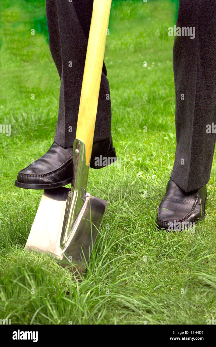 Foot on spade, ground-breaking ceremony Stock Photo - Alamy