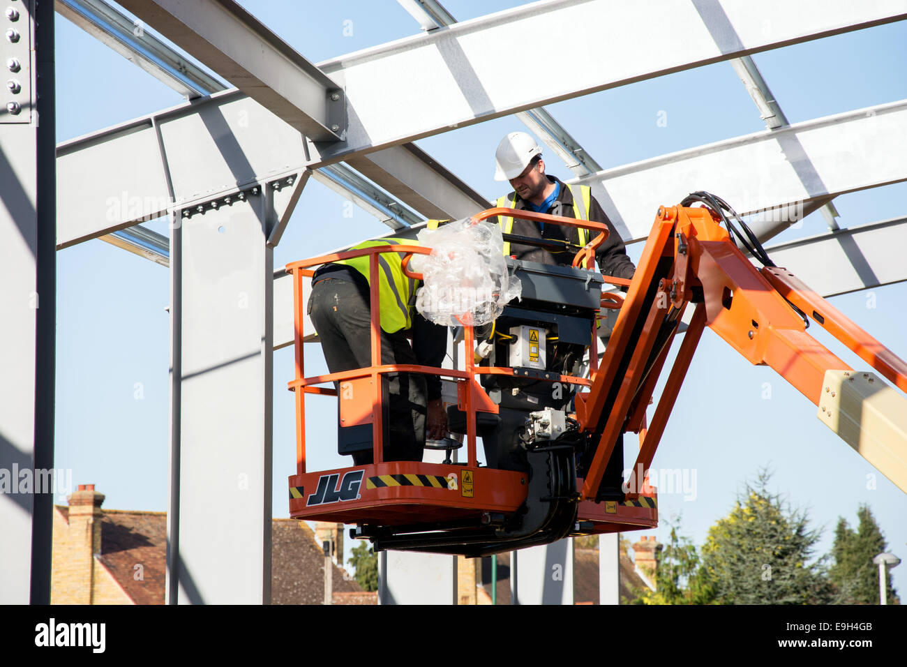 Metal building frame with workmen Stock Photo - Alamy