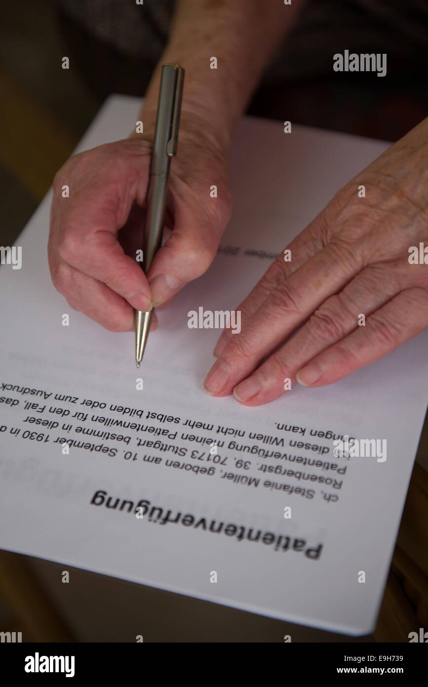 Senior woman signing document hi-res stock photography and images - Alamy