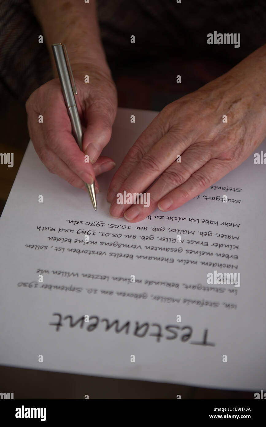 Senior woman signing document hi-res stock photography and images - Alamy