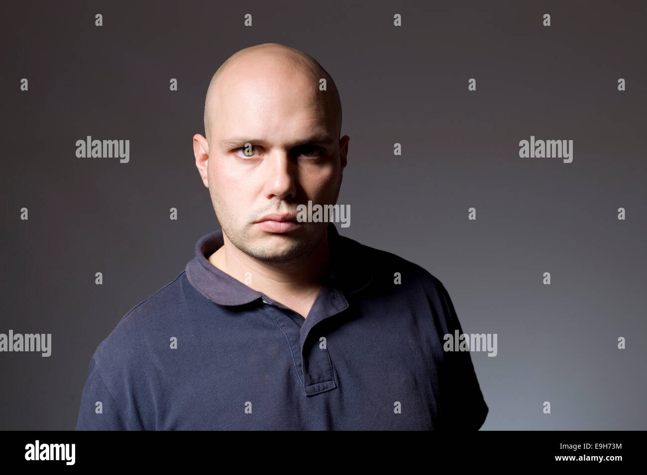 Portrait of young man thinking on a black background Stock Photo - Alamy