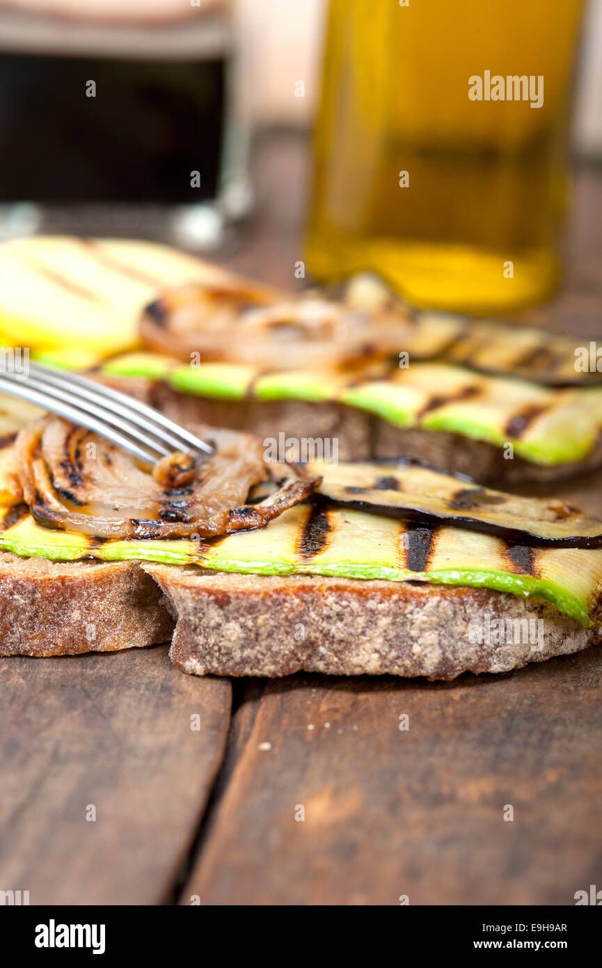 grilled vegetables on rustic bread over wood table Stock Photo - Alamy