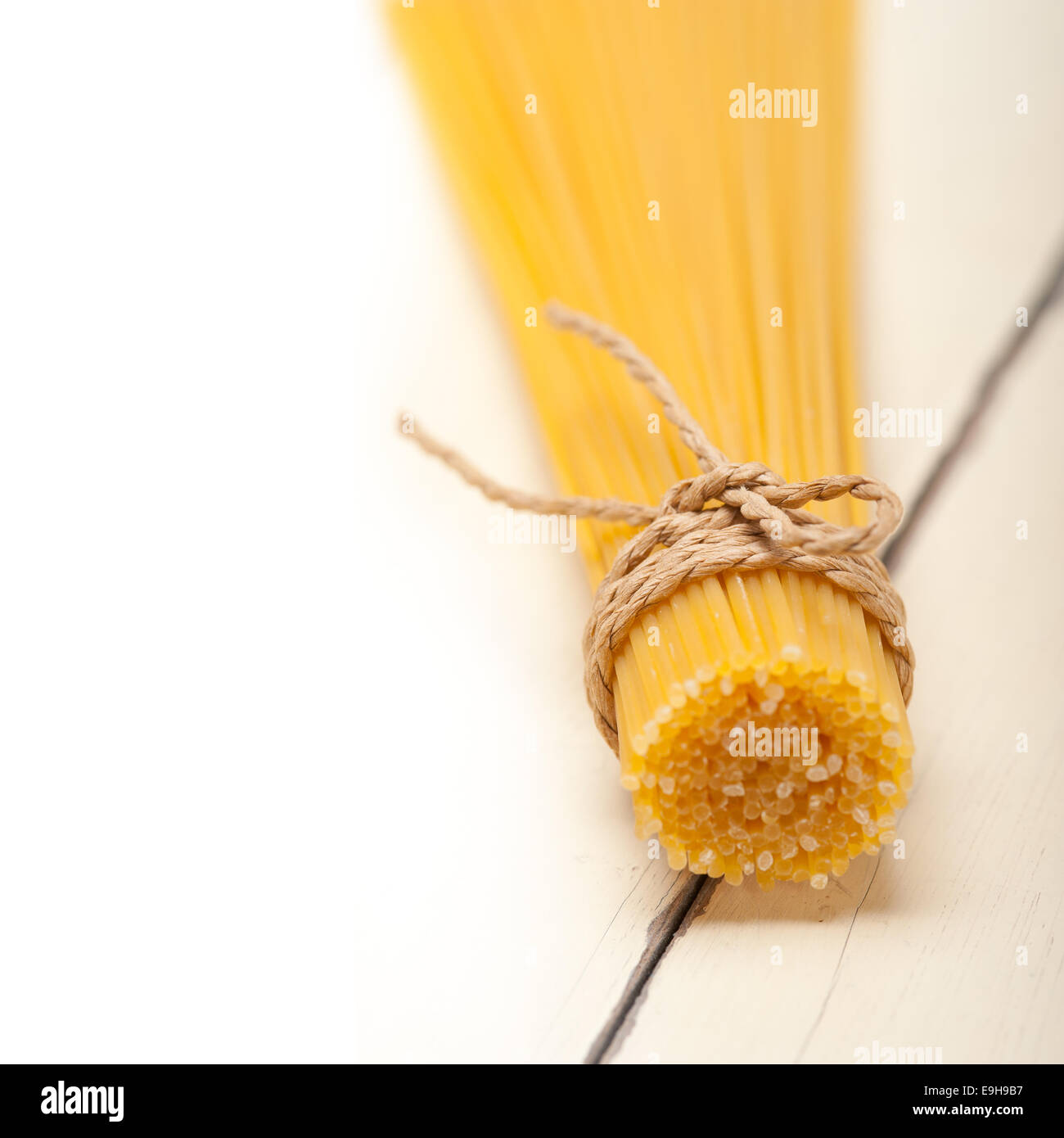 Italian pasta spaghetti tied with a rope on a rustic table Stock Photo ...