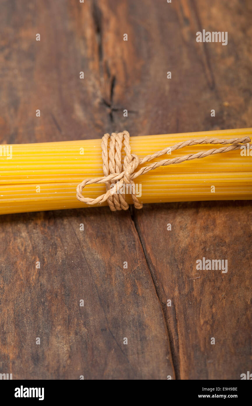 Italian pasta spaghetti tied with a rope on a rustic table Stock Photo ...