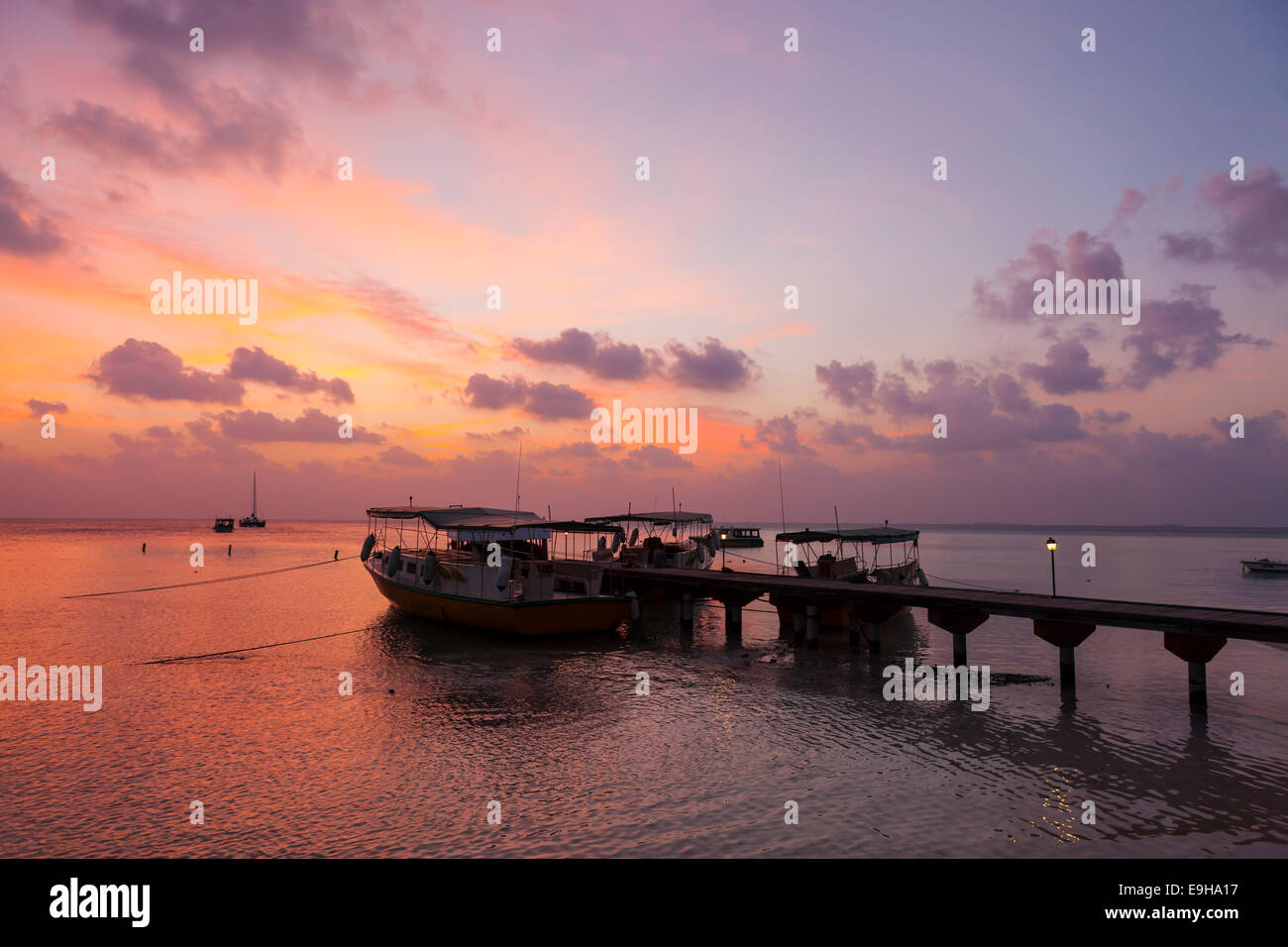 Boats at a jetty at sunset, Malé, North Malé Atoll, Maldives Stock ...