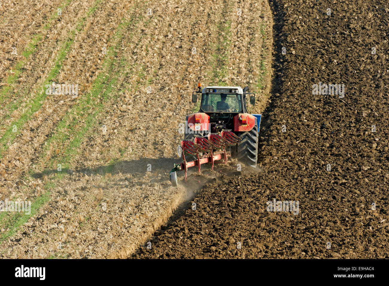 Harvested field is plowed with tractor and plow, Upper Bavaria, Bavaria ...