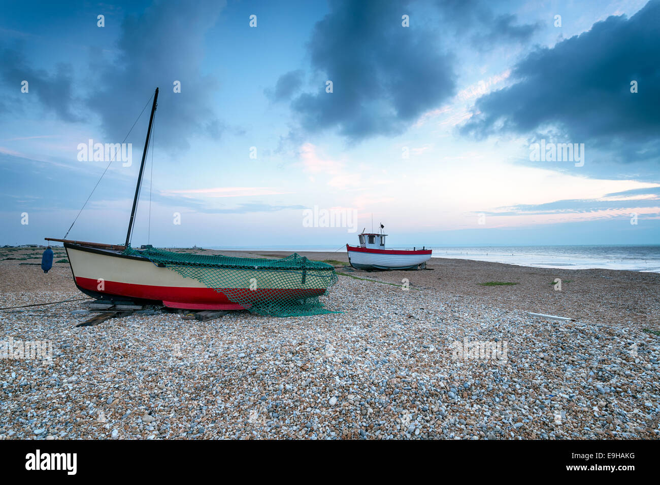 Boats on a pebble beach Stock Photo - Alamy