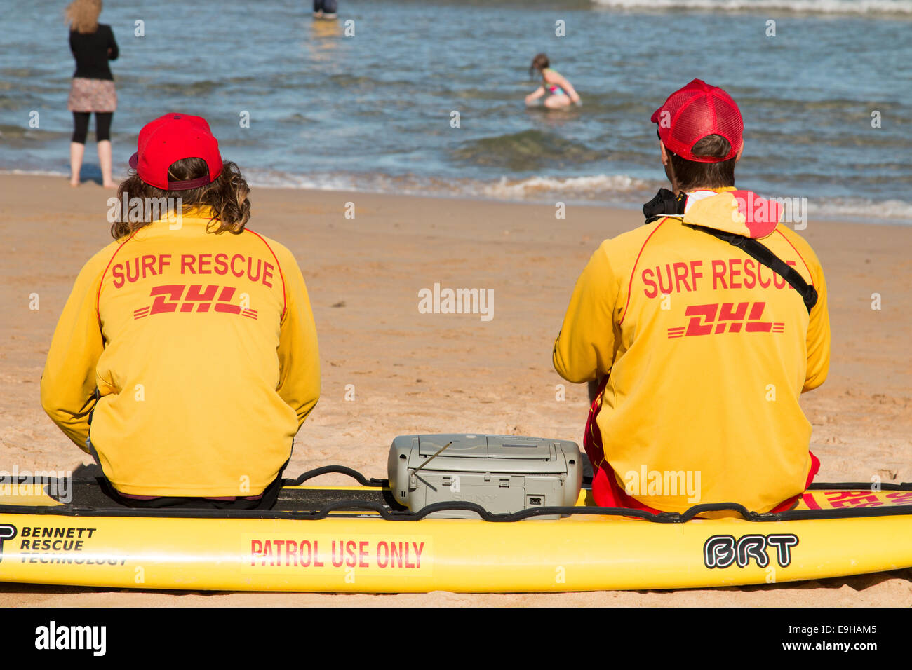 two sydney surf rescue teenagers male and female sitting on a patrol ...