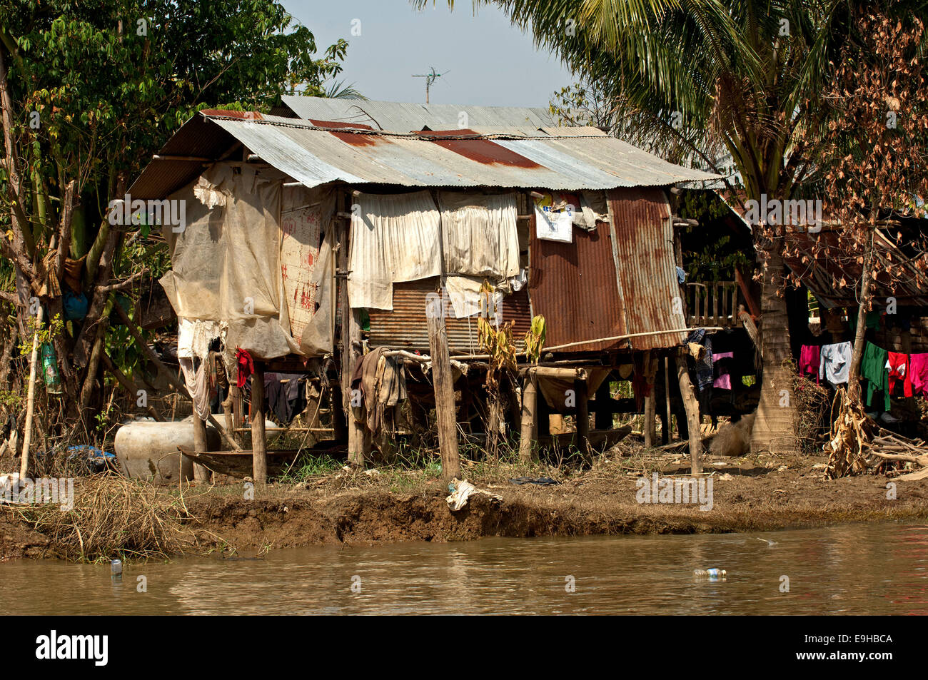 Shack, corrugated iron hut at the Sangker River, near Battambang ...