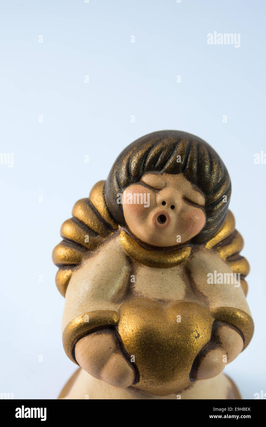 Little gold angel with a big hearth Stock Photo - Alamy
