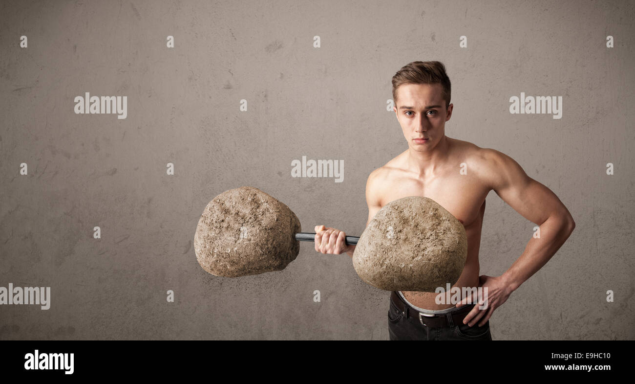 muscular man lifting large rock stone weights Stock Photo - Alamy