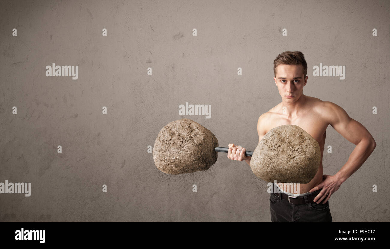 muscular man lifting large rock stone weights Stock Photo - Alamy