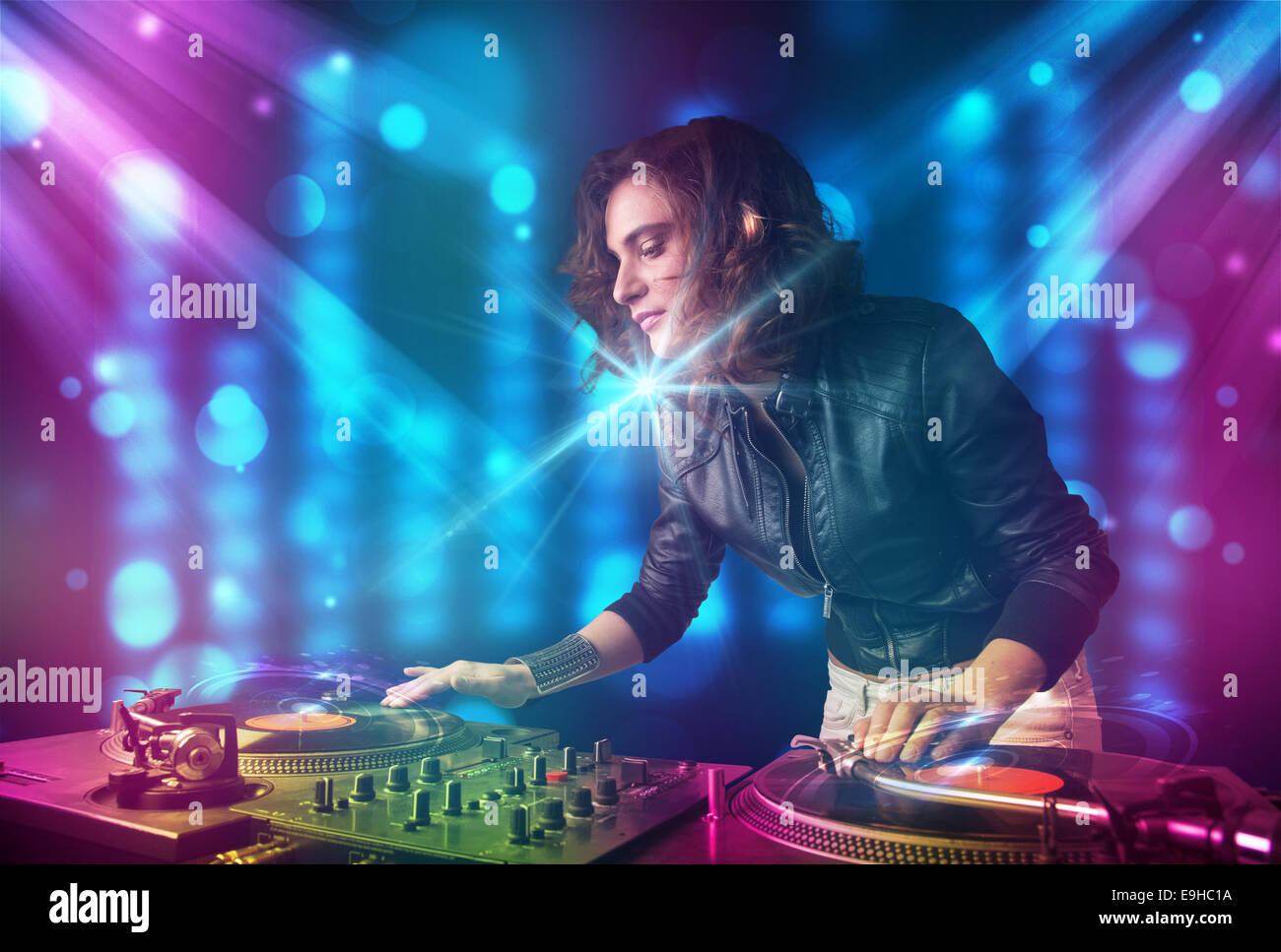 Dj girl mixing music in a club with blue and purple lights Stock Photo ...