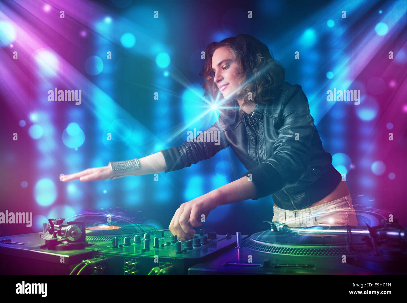 Dj girl mixing music in a club with blue and purple lights Stock Photo ...