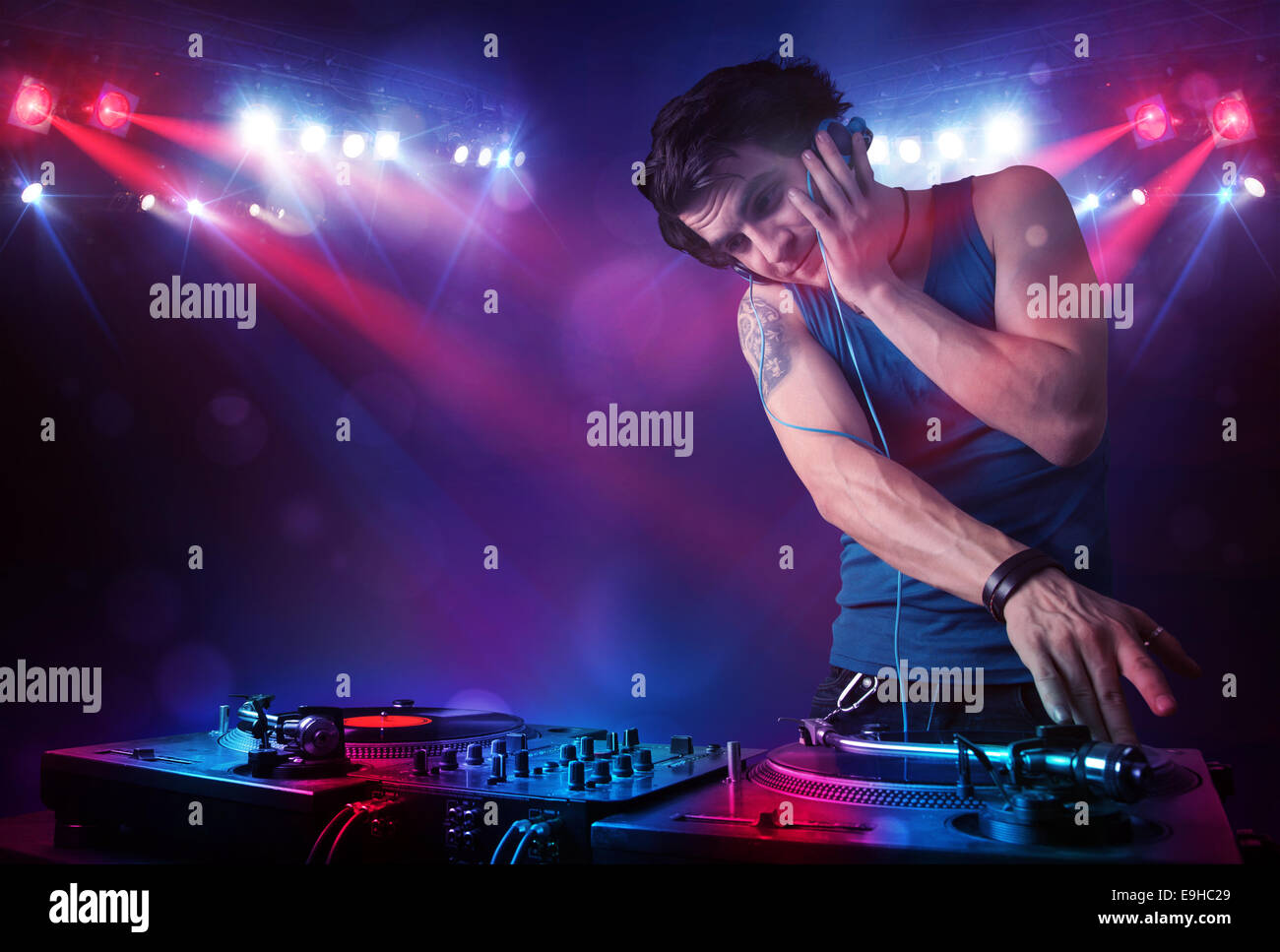 Teenager dj mixing records in front of a crowd on stage Stock Photo - Alamy