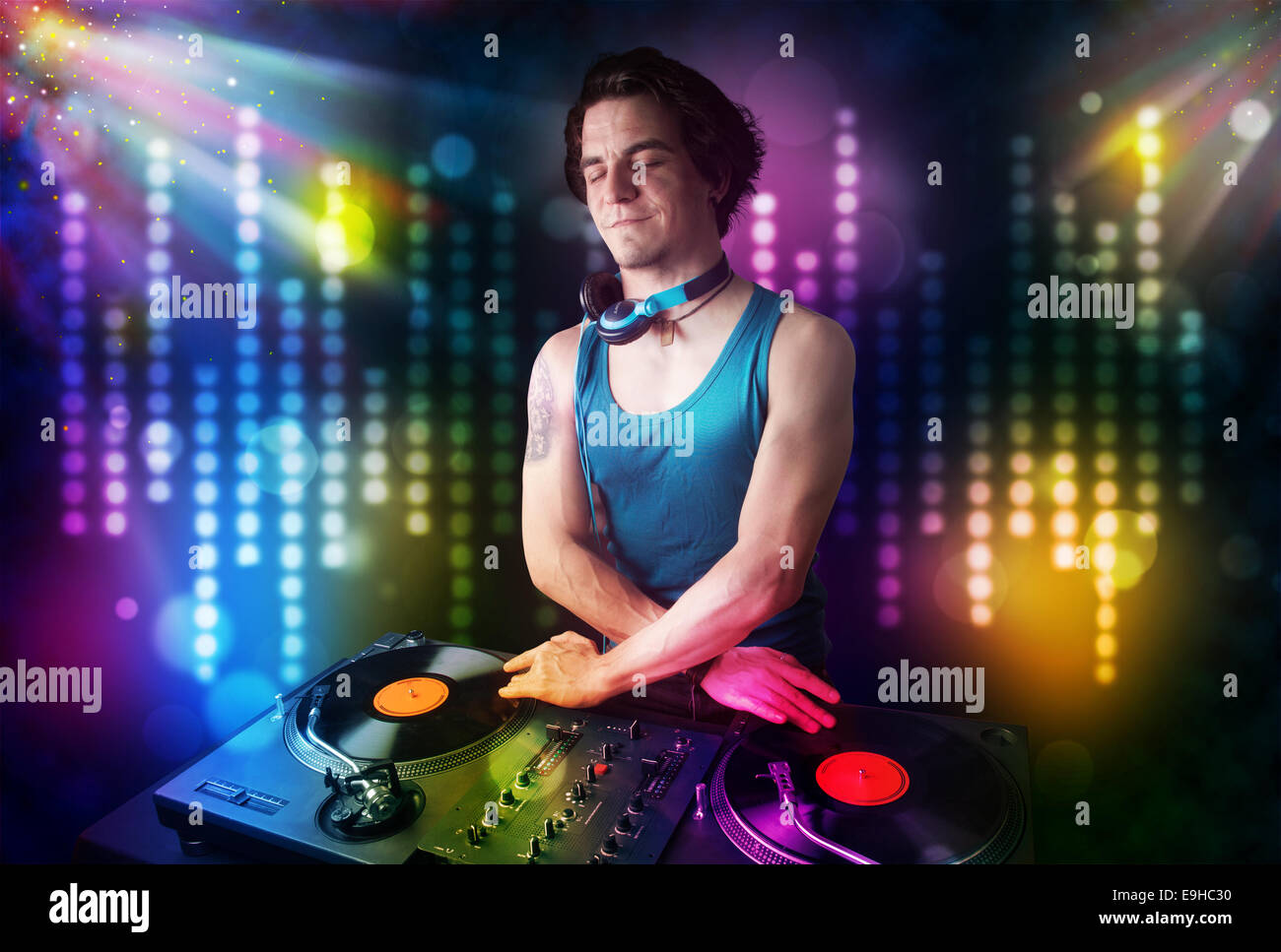 Dj playing songs in a disco with light show Stock Photo - Alamy