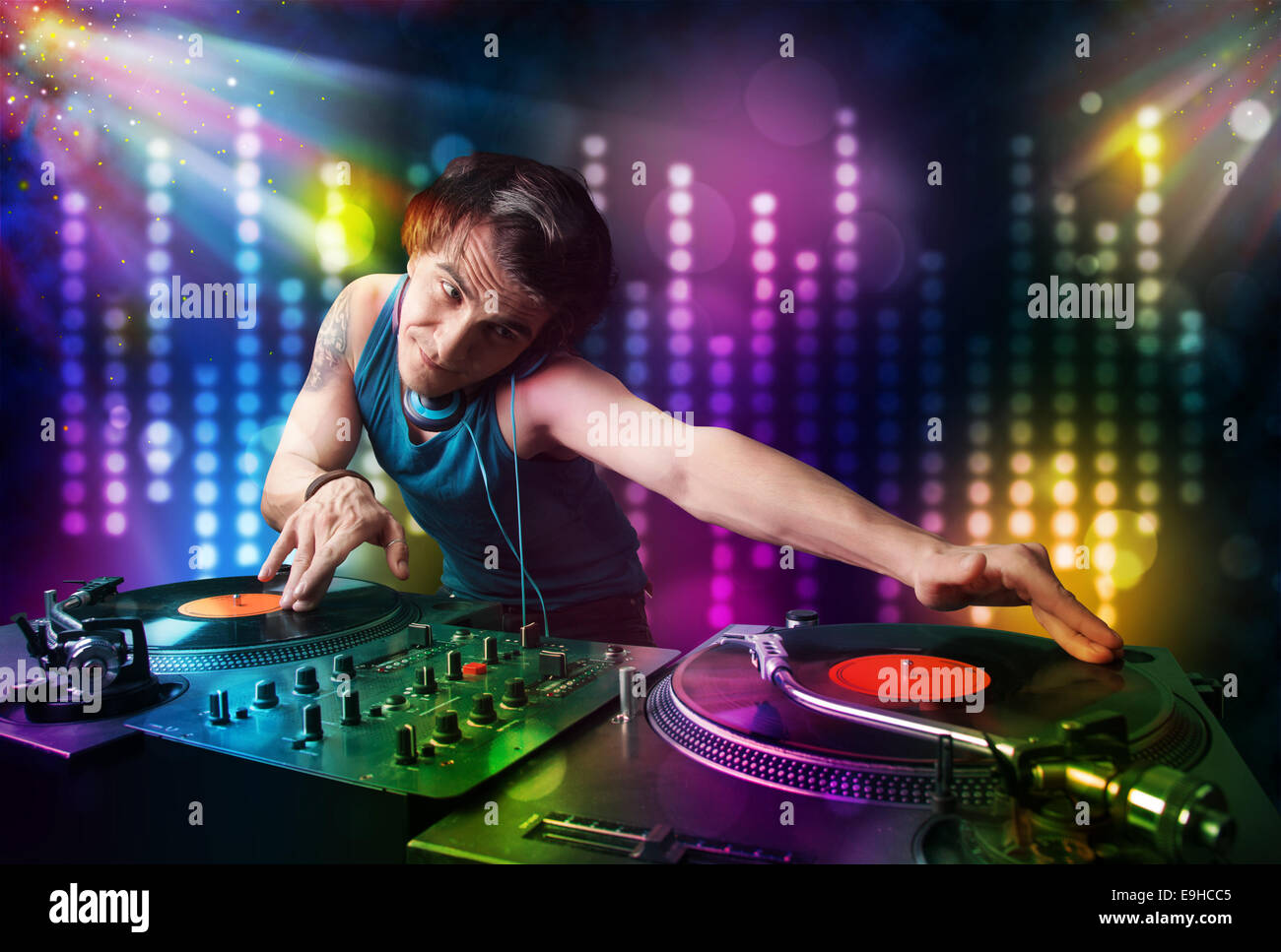 Dj playing songs in a disco with light show Stock Photo - Alamy