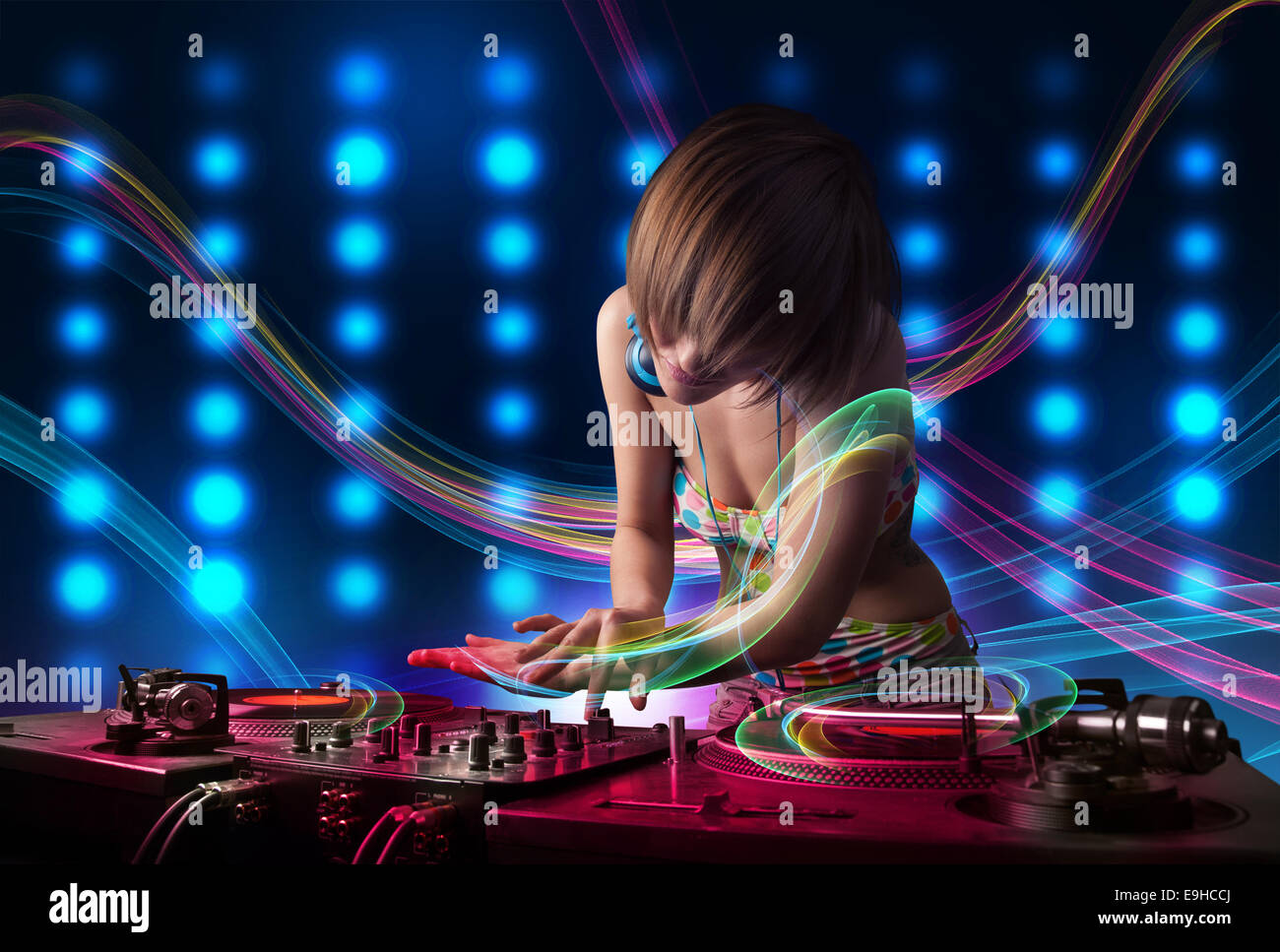 Young Dj girl mixing records with colorful lights Stock Photo - Alamy