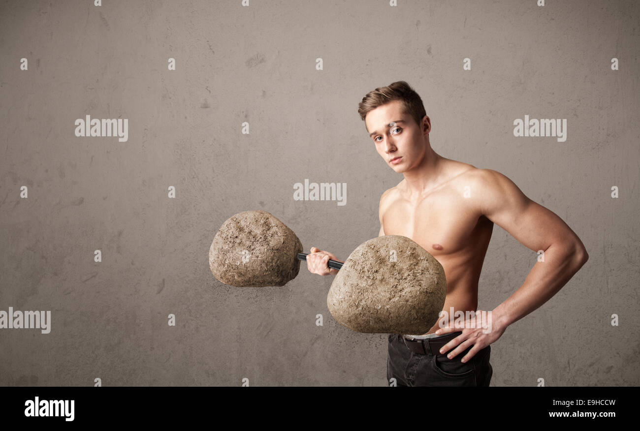 muscular man lifting large rock stone weights Stock Photo - Alamy
