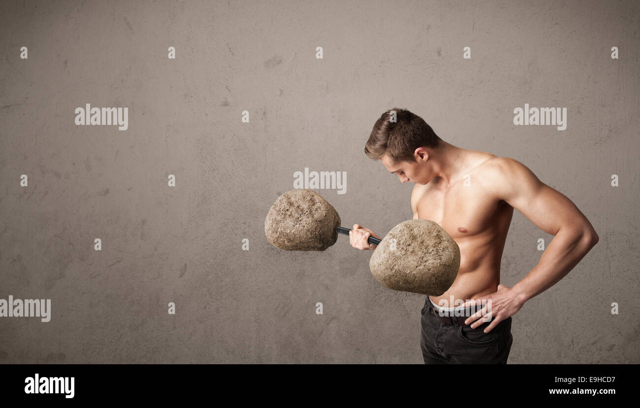 muscular man lifting large rock stone weights Stock Photo - Alamy