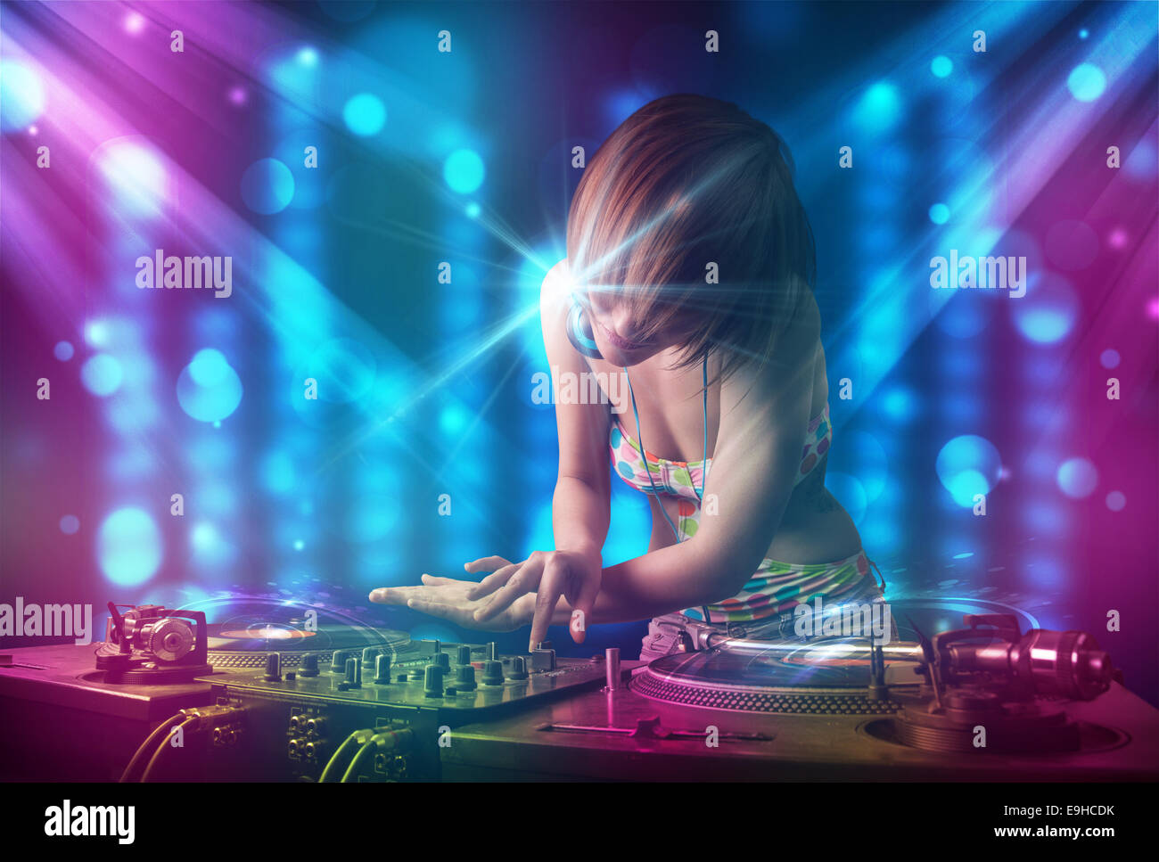 Dj girl mixing music in a club with blue and purple lights Stock Photo ...