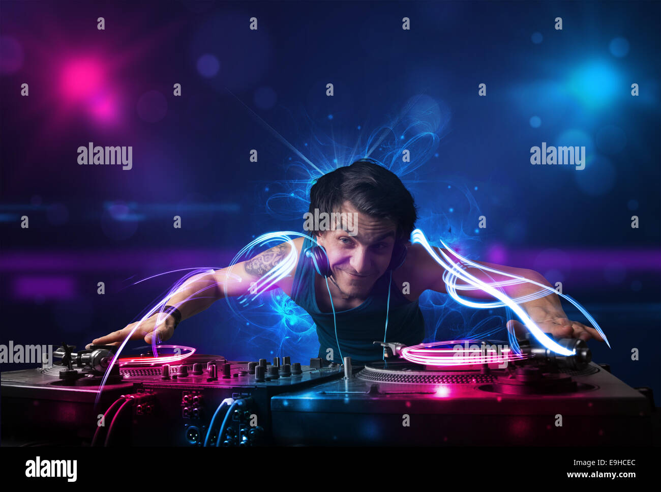 Disc jockey playing music with electro light effects and lights Stock ...