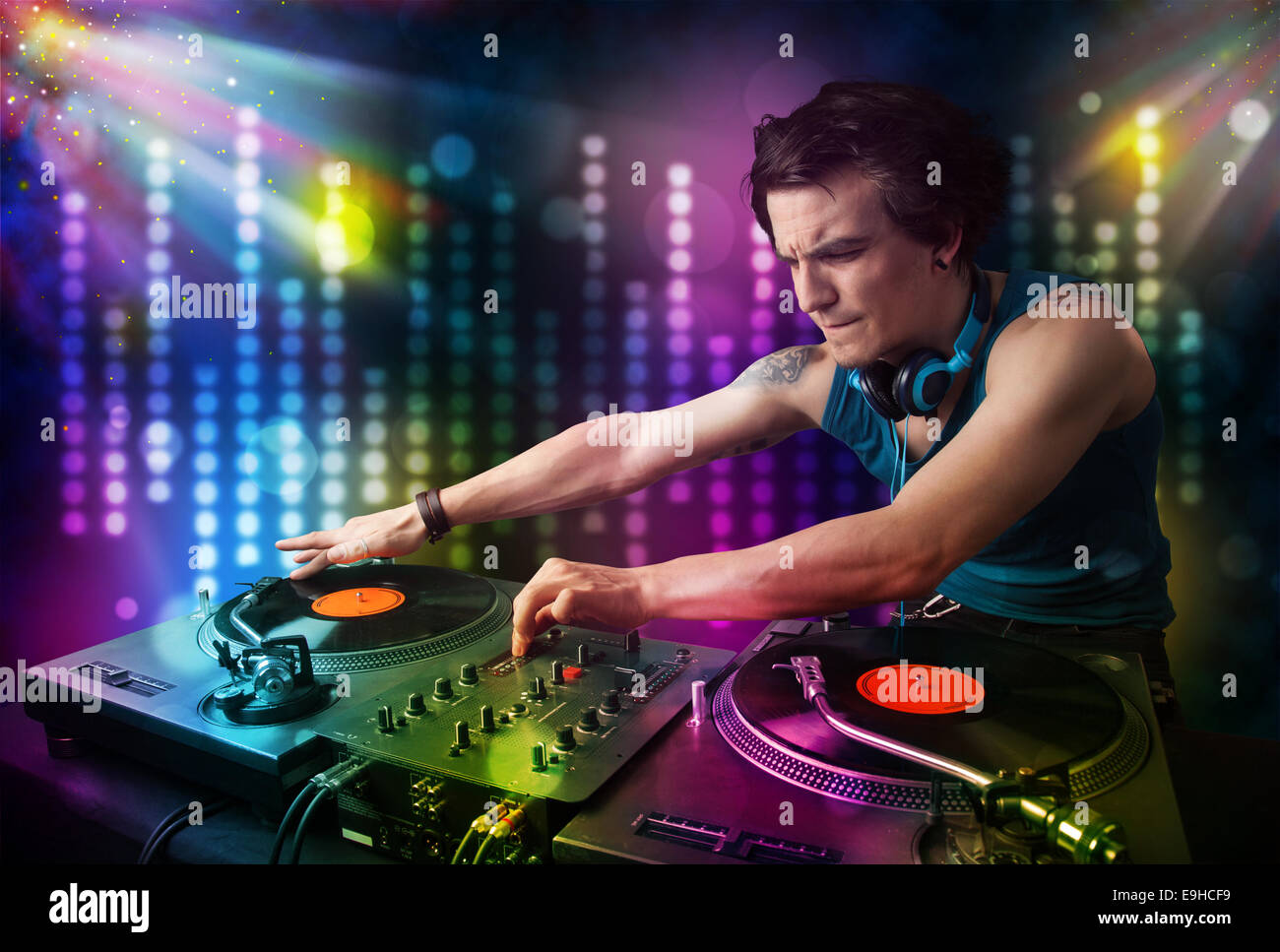 Dj playing songs in a disco with light show Stock Photo - Alamy