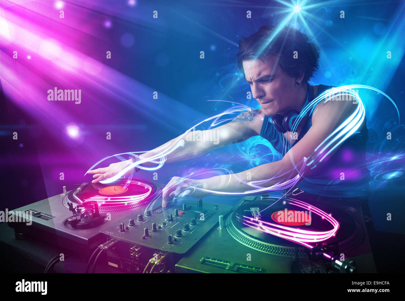 Energetic Dj mixing music with powerful light effects Stock Photo - Alamy
