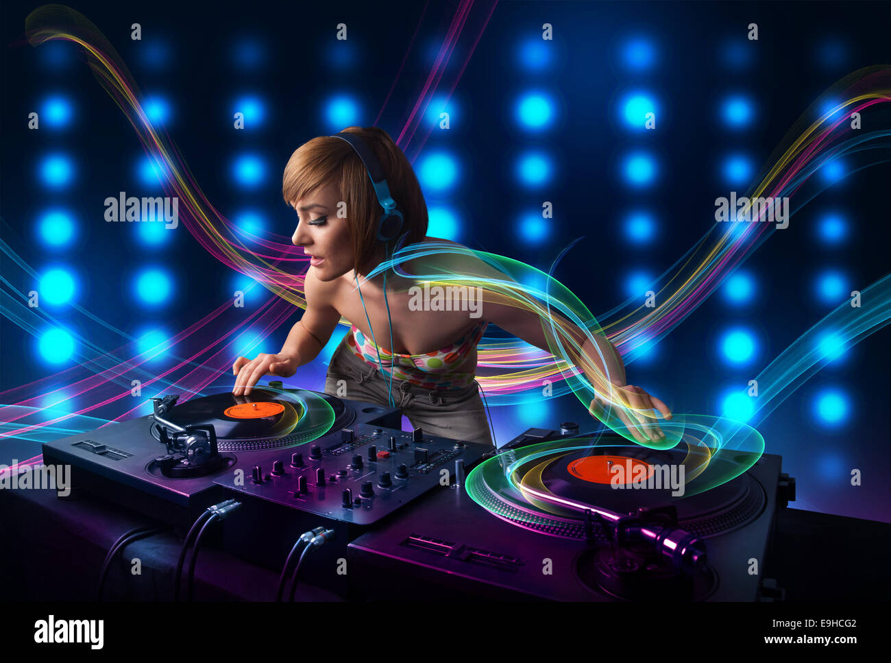 Young Dj girl mixing records with colorful lights Stock Photo - Alamy