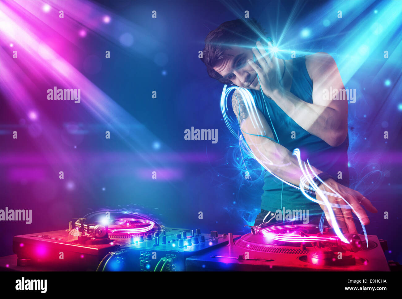 Energetic Dj mixing music with powerful light effects Stock Photo - Alamy