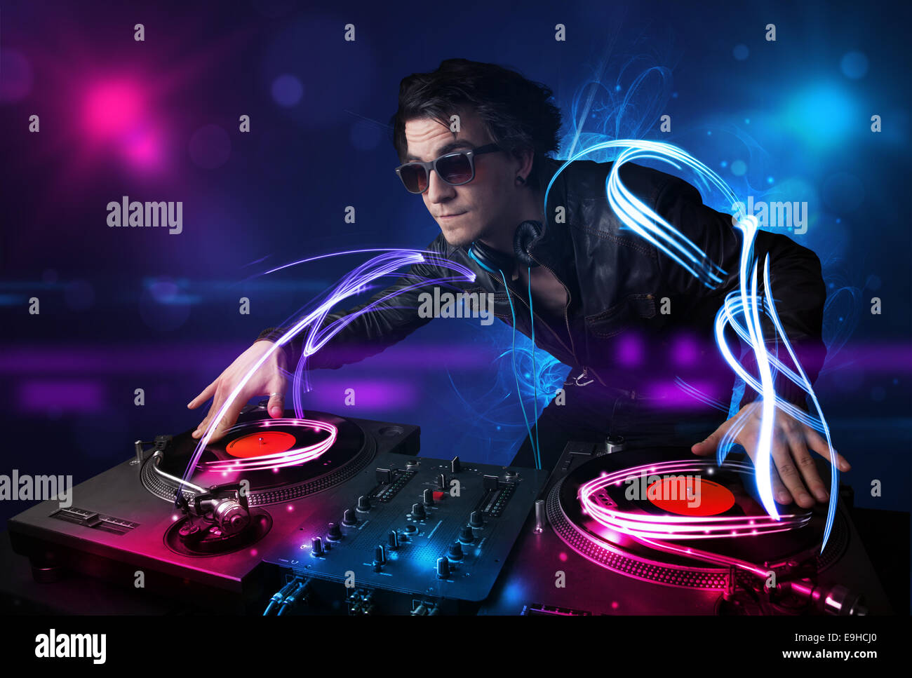 Disc jockey playing music with electro light effects and lights Stock ...