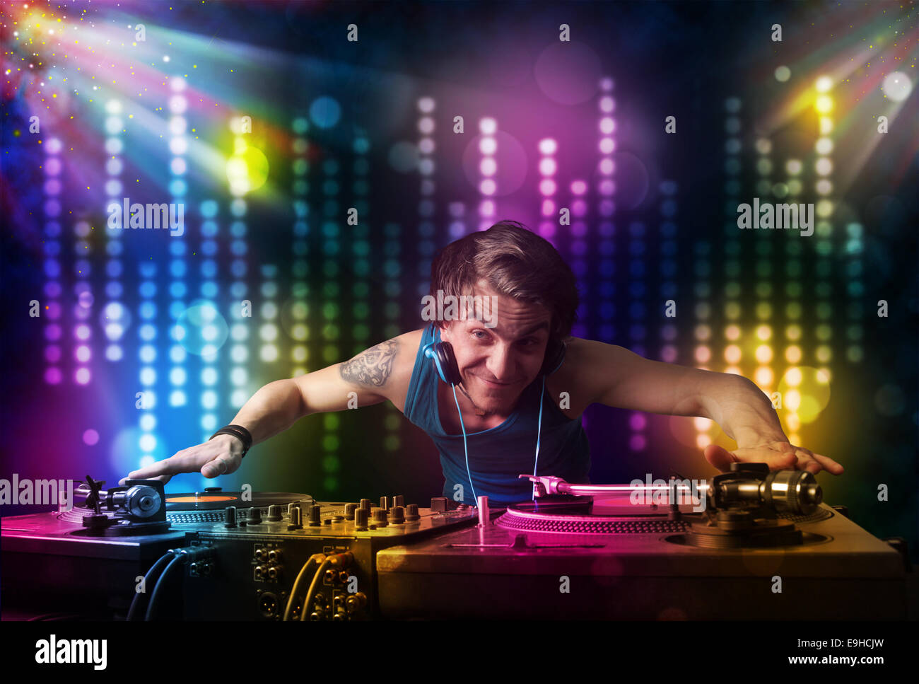 Dj playing songs in a disco with light show Stock Photo - Alamy