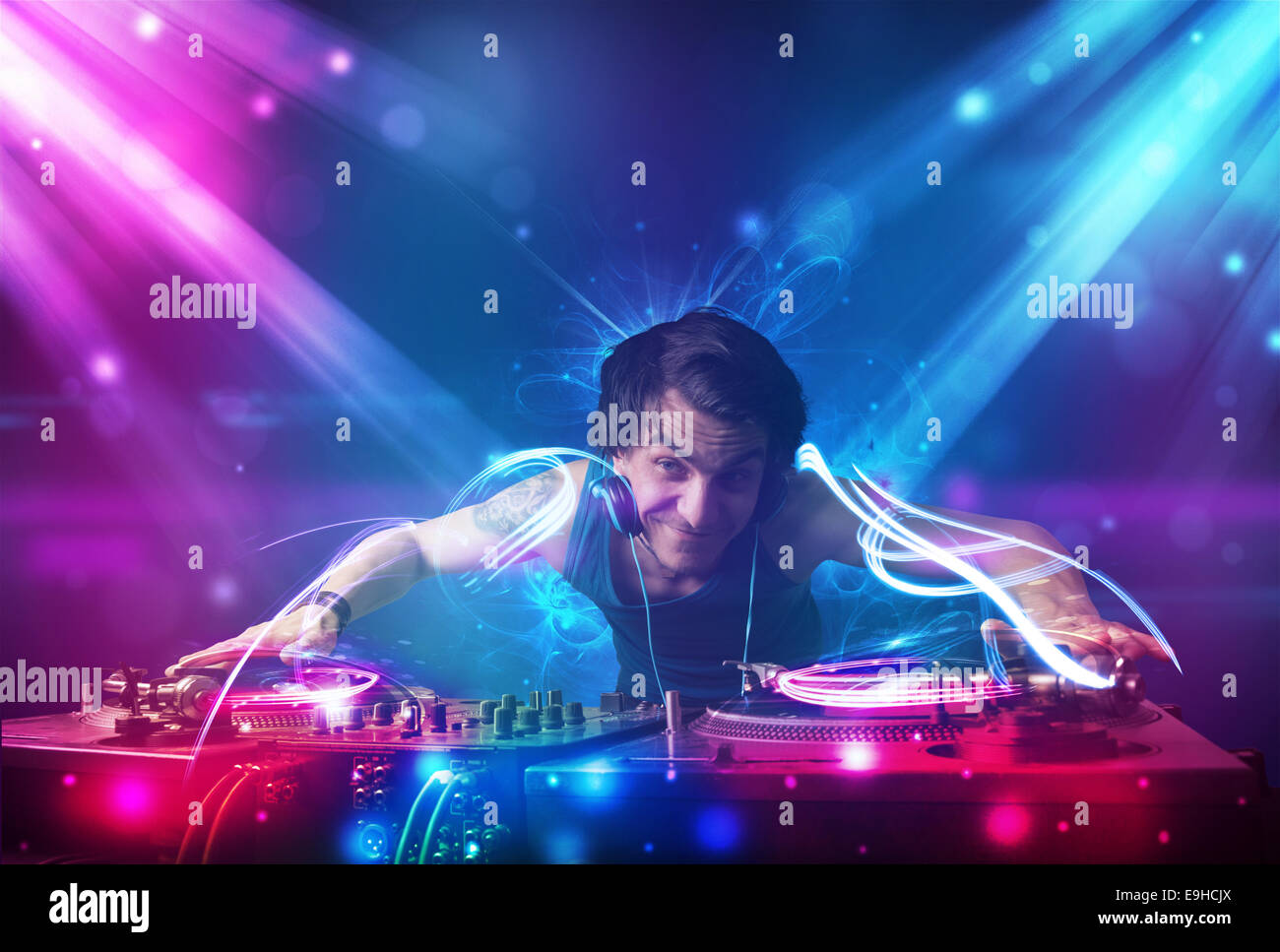 Energetic Dj mixing music with powerful light effects Stock Photo - Alamy