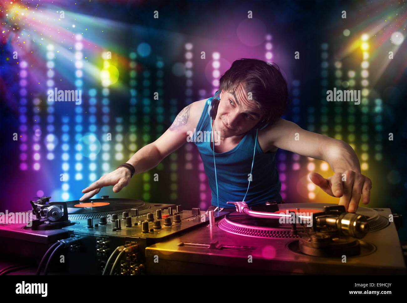 Dj playing songs in a disco with light show Stock Photo - Alamy