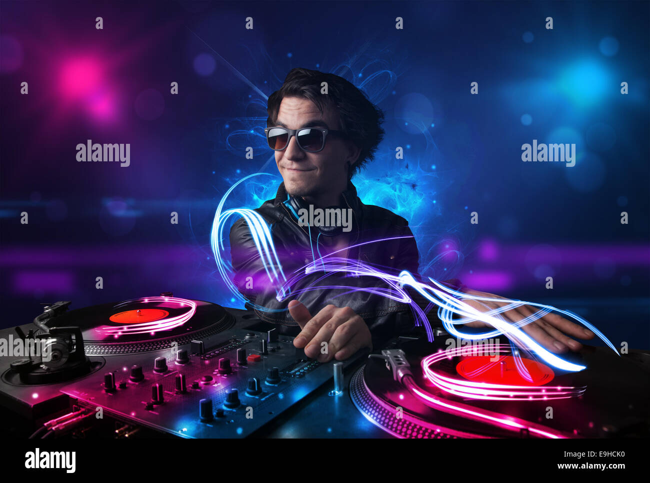 Disc jockey playing music with electro light effects and lights Stock ...